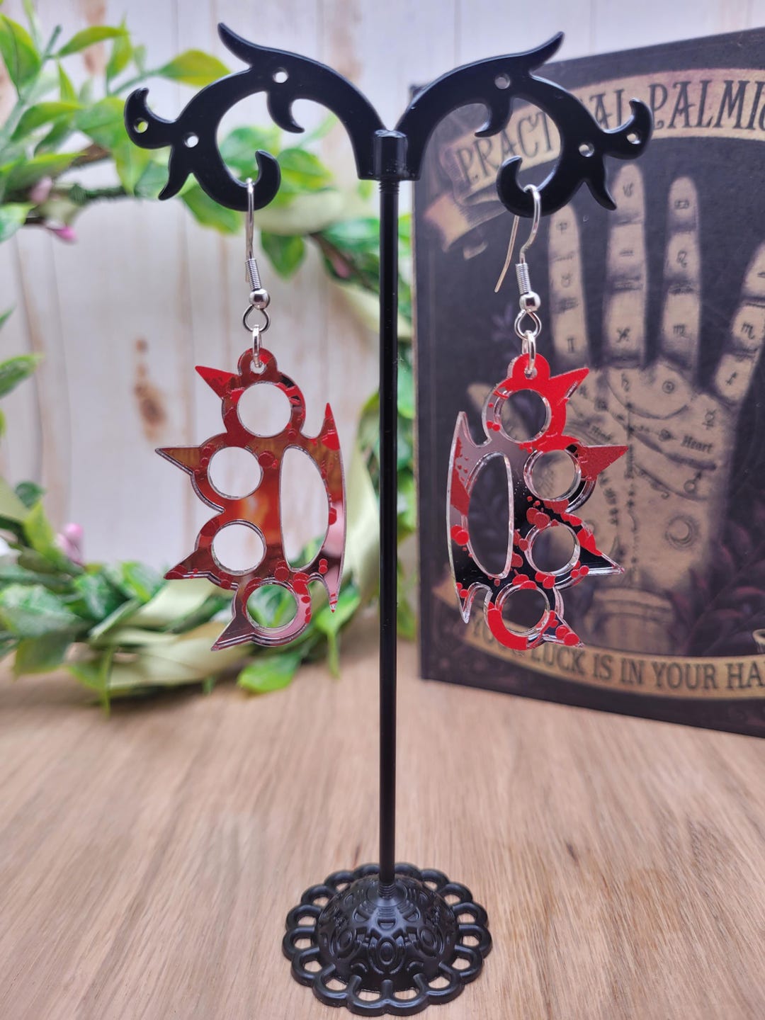 Brass Knuckles Covered in Blood Splatter on Silver Mirror Acrylic ...