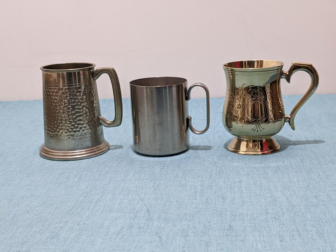 A Vintage Trio of Metal Mugs and Tankards Three Metals and Designs to ...
