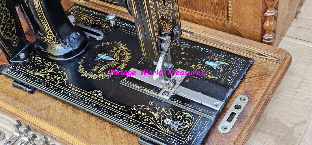 The Robina Sewing Machine With a Central Robin and Cupids at Each ...
