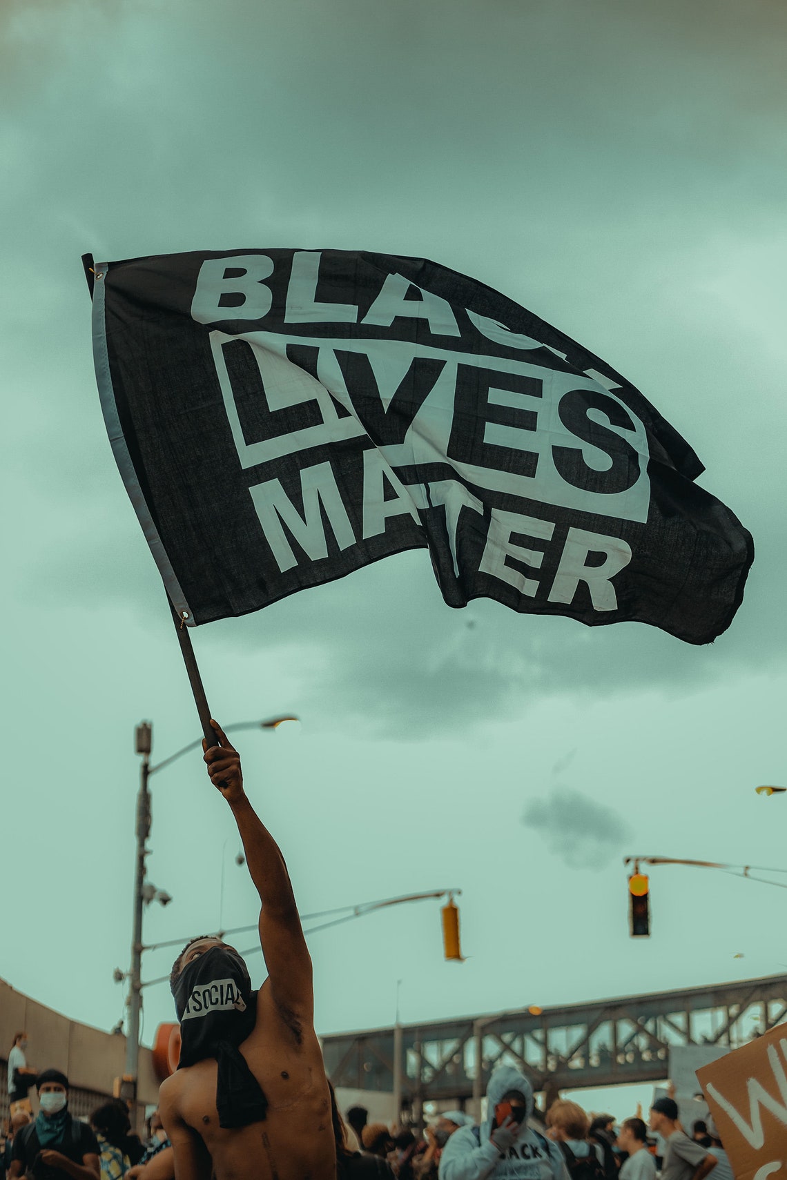 Protestor holds BLM flag | Etsy