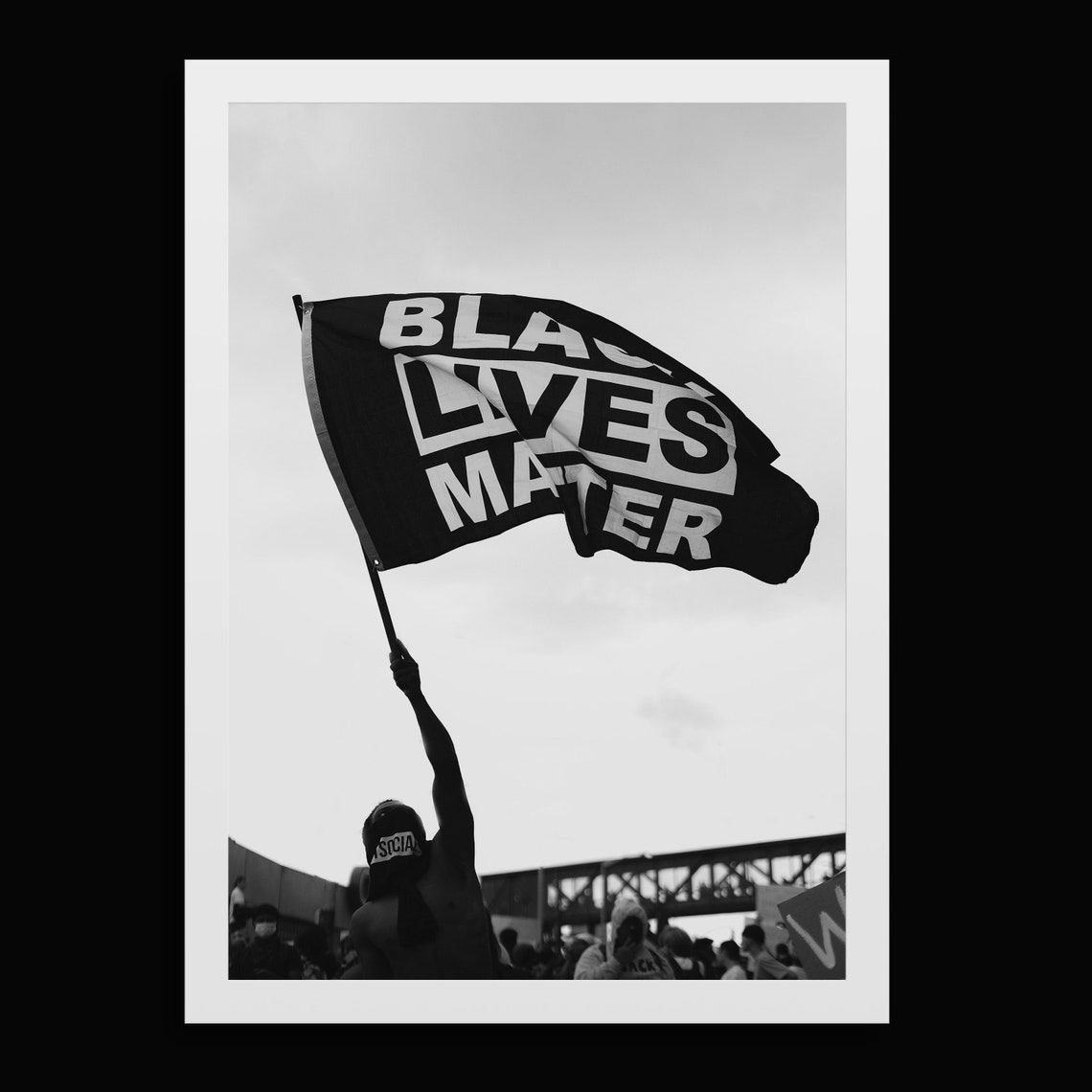Protestor holds BLM flag | Etsy