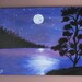 Purple Moonglow Over Shimmering Water With Silhouetted Trees and Hill ...