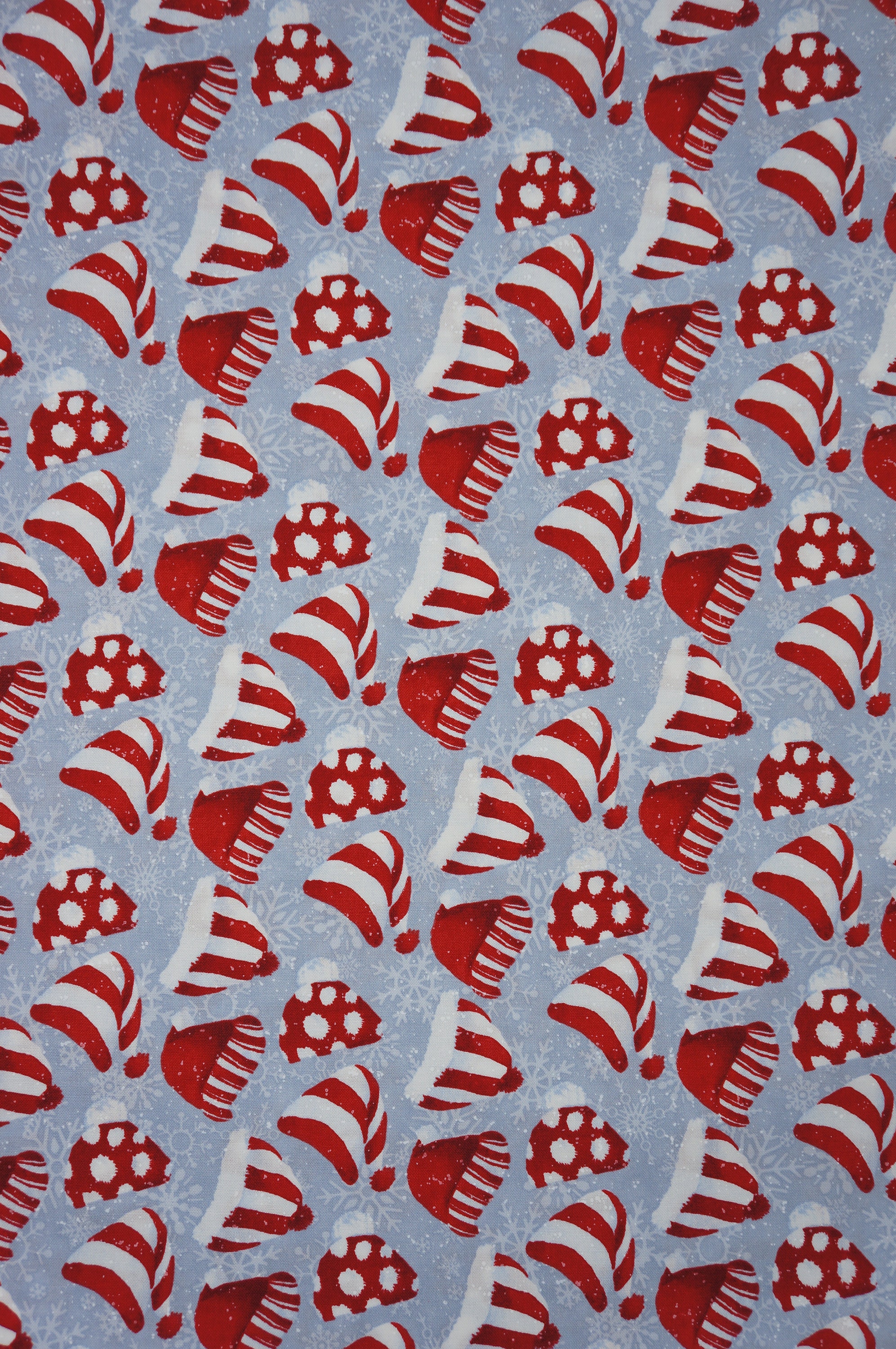 Tossed Red and White Christmas Hats on Bluish Gray From Tossed Red and White Christmas Hats on Bluish Gray From