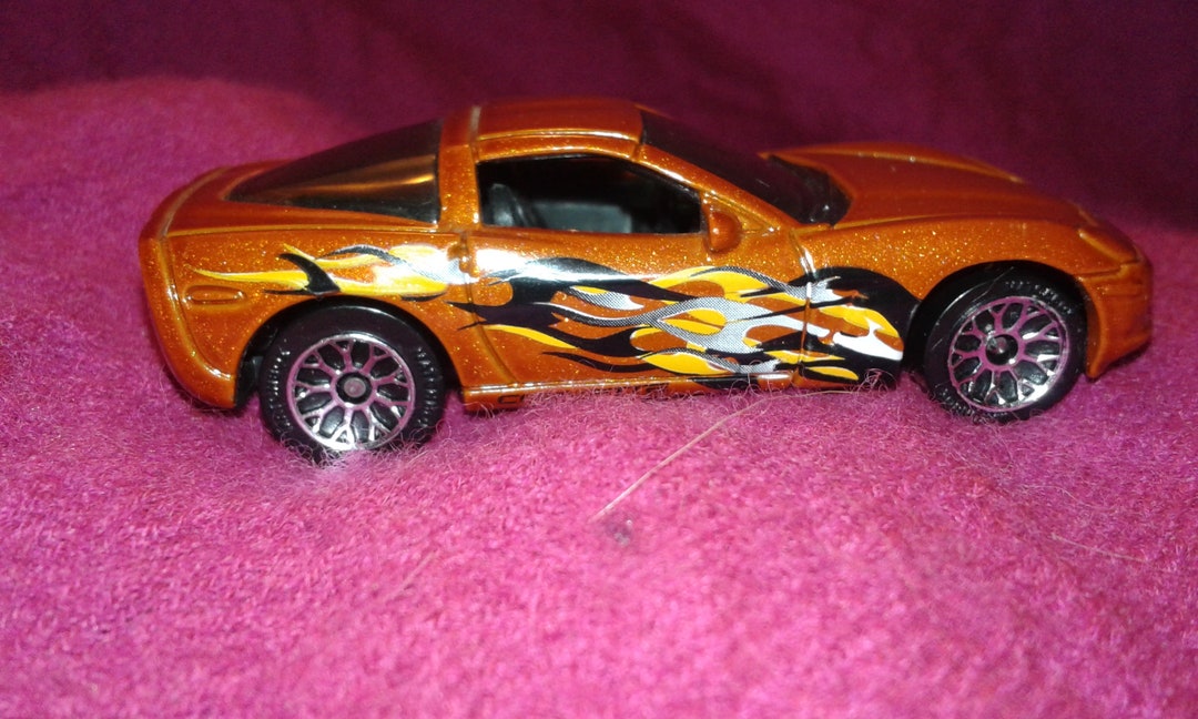 A Chevrolet Corvette C5 Toy Car by Mattel, in Rust Colour, With Flames ...