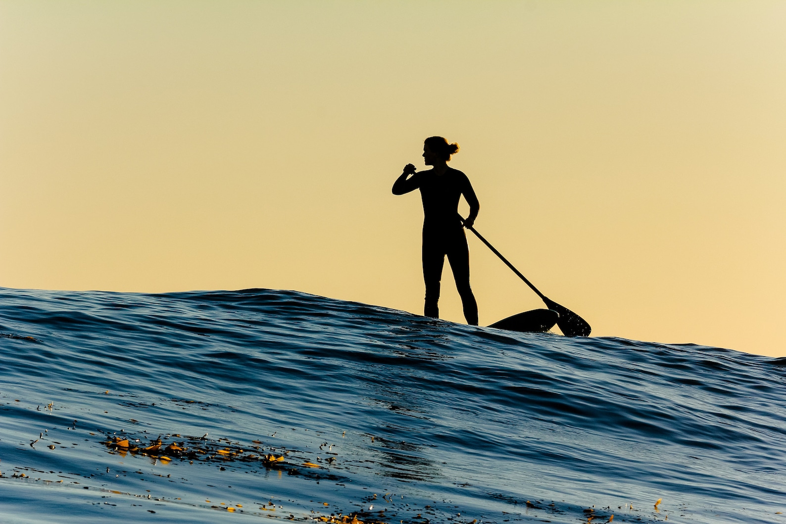 Paddleboarder Standing at Sea in Choppy Water at Sunset, Summer ...