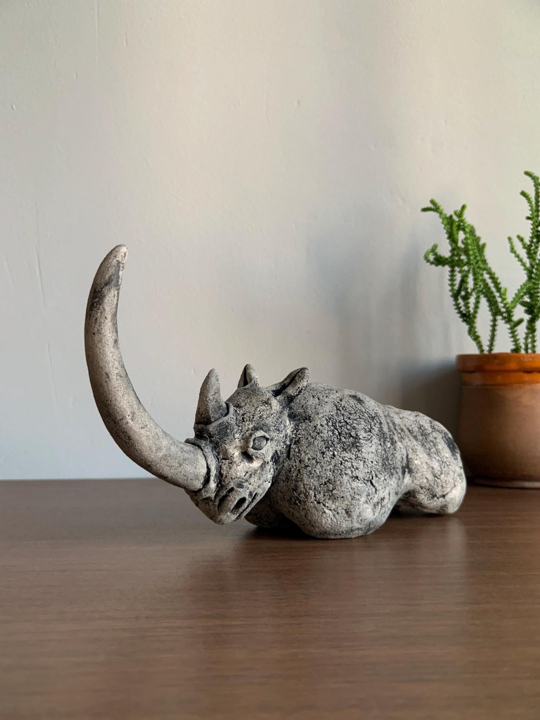 A Ceramic Rhinoceros Figurine Made of Natural Clay, a Rhinoceros ...