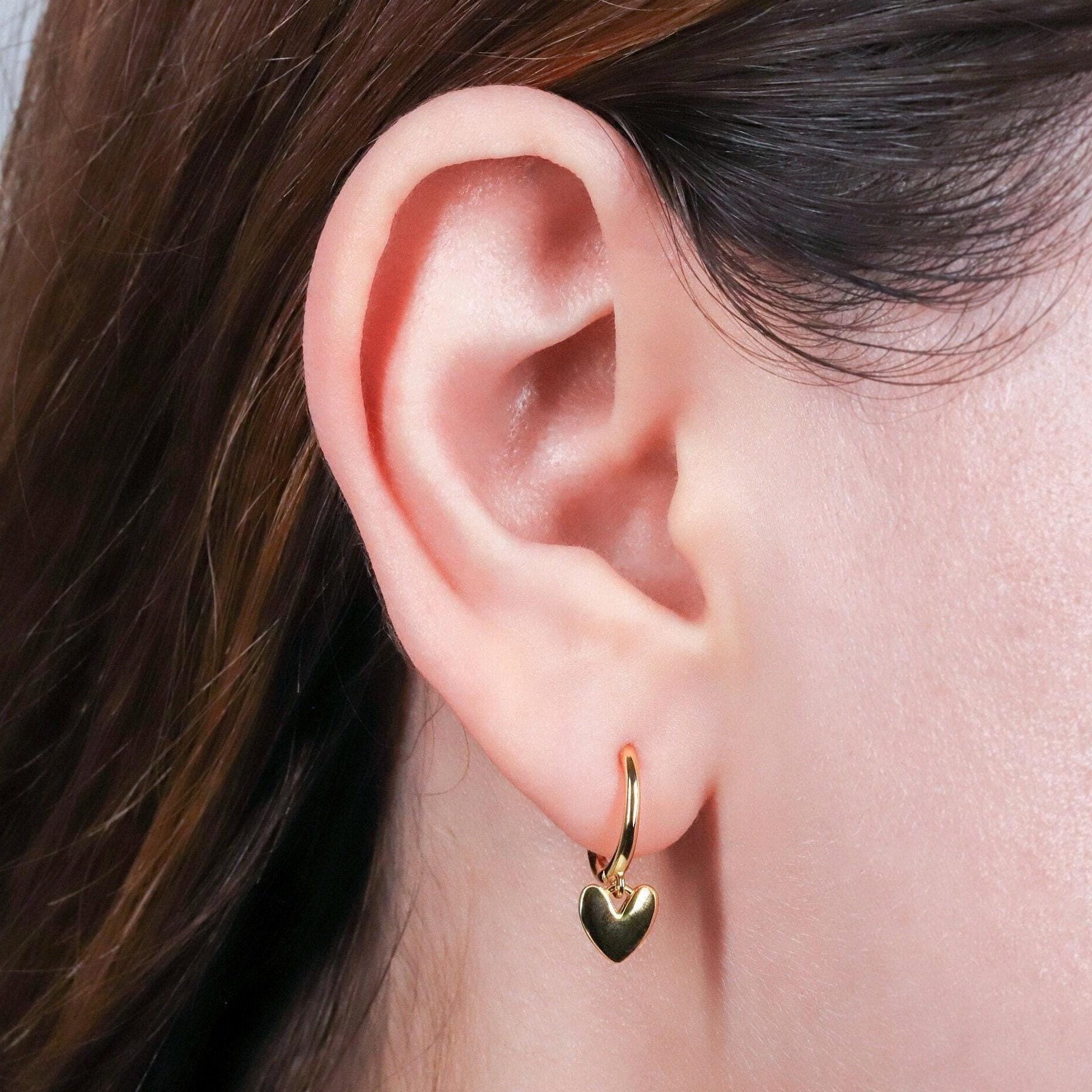 Dangling gold heart earrings store