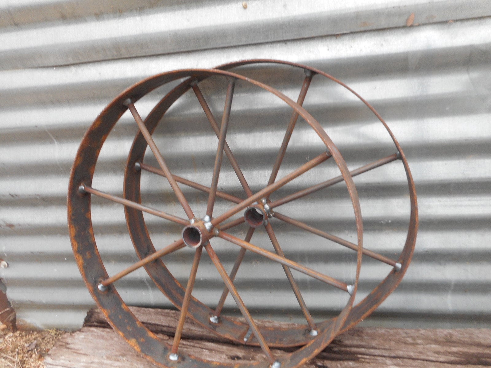 A Pair of 24" Steel Wagon Wheels , Rustic Art Bar B Q Pits Wagons Etc ...