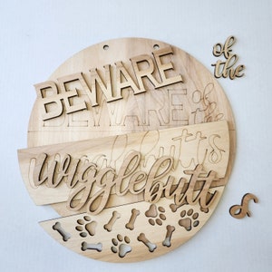 Beware of the Wigglebutts Plural Dog Lover Sign Round Door Hanger ...