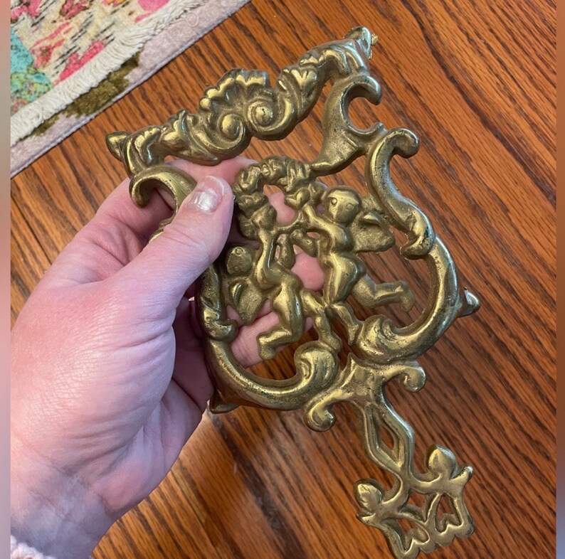 Vintage Footed Trivet in Gold - Ornate With Cherubs Cupids Scrolls ...