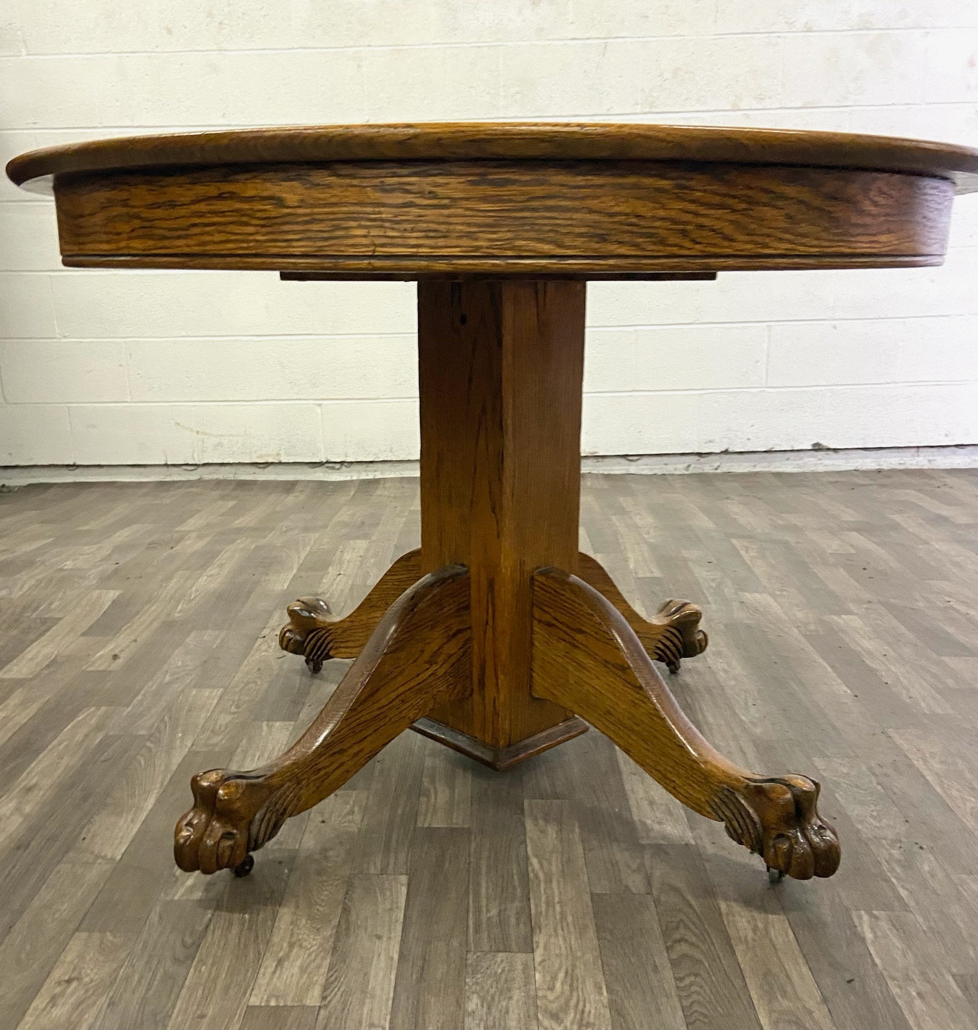 Antique Tiger Oak 42 Inch Round Claw Foot Dining Table with Two Leaves