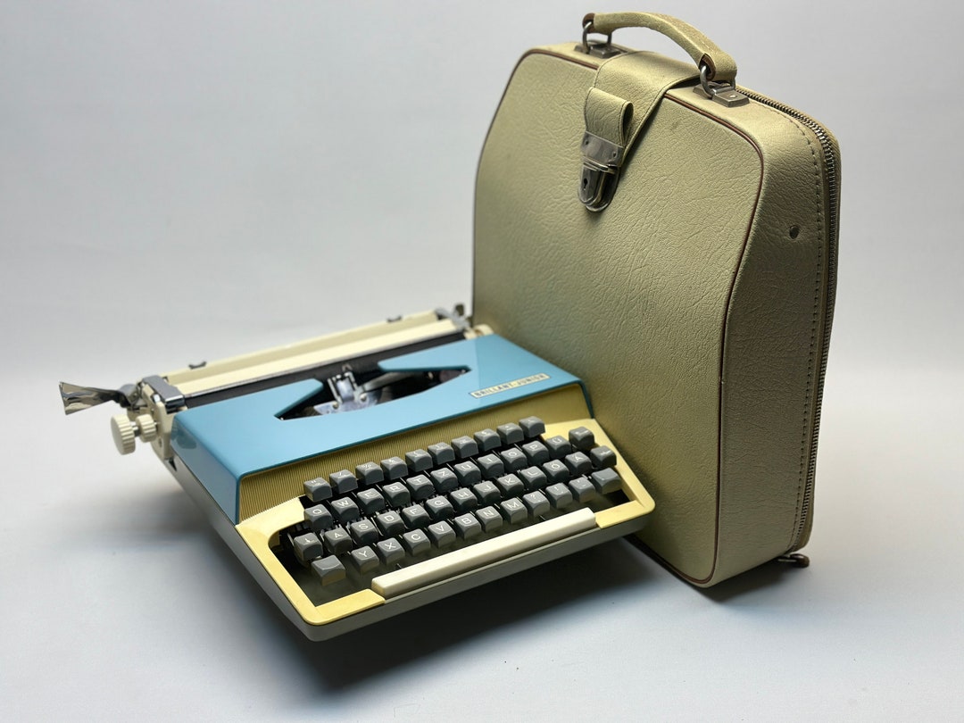 Brilliant Typewriter With Blue Cover, Yellow Accents, Pink Ribbon, and ...