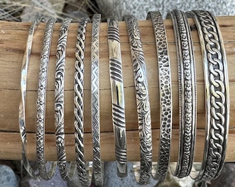 Multiple silver bangles store