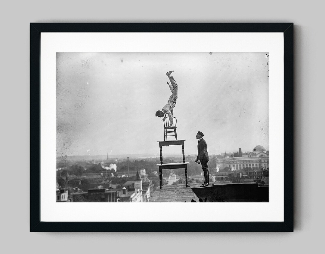 Daredevil Stunt Man Balances Dangerously Atop a Chair on a City ...