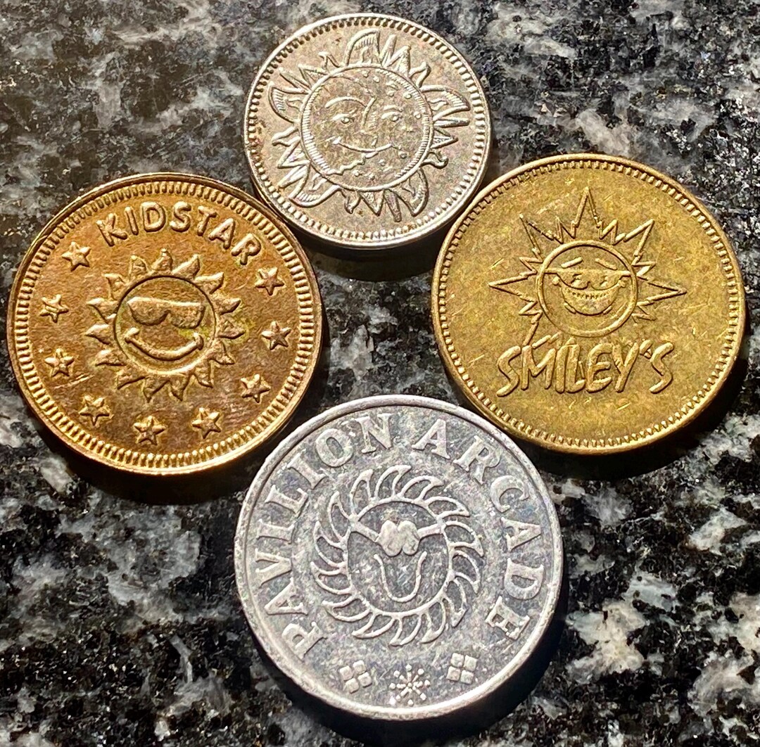 A Group of 4 Different Sunburst Theme Coins. Brass & Chrome Amusement ...