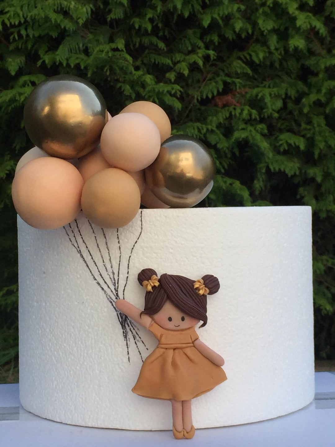 Figure in Sugar Paste on Top of Cake Spheres and Girl. Fondant or Cold ...