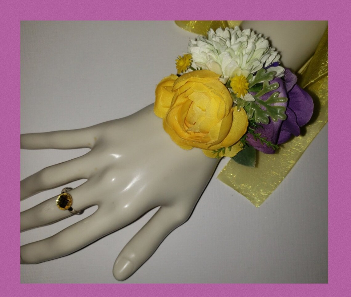 This is a Corsage With Yellow, Purple and Mint Green Artificial Flowers ...