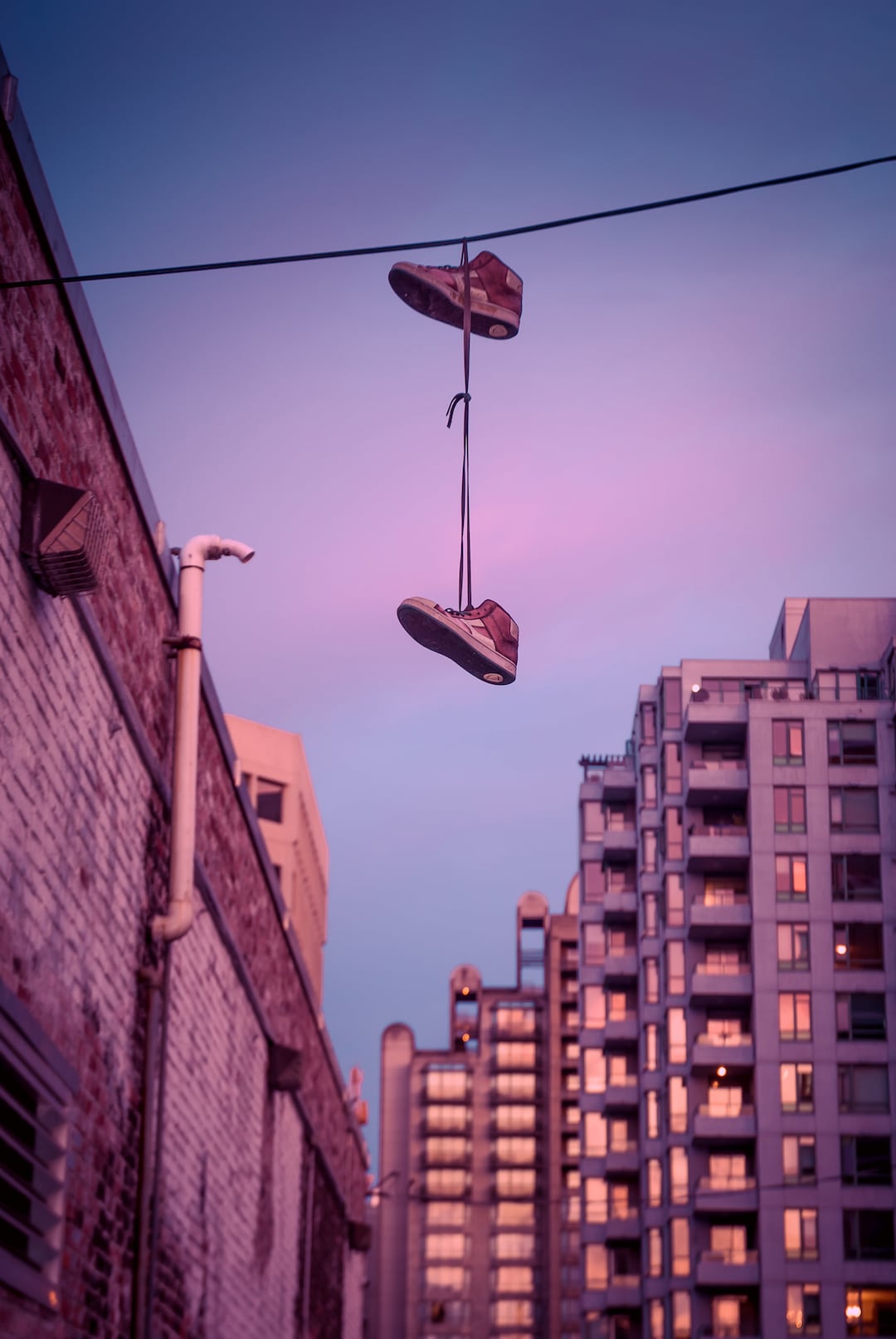 Hightop Shoes Hanging From Power Lines in an Urban Setting at Sunset ...
