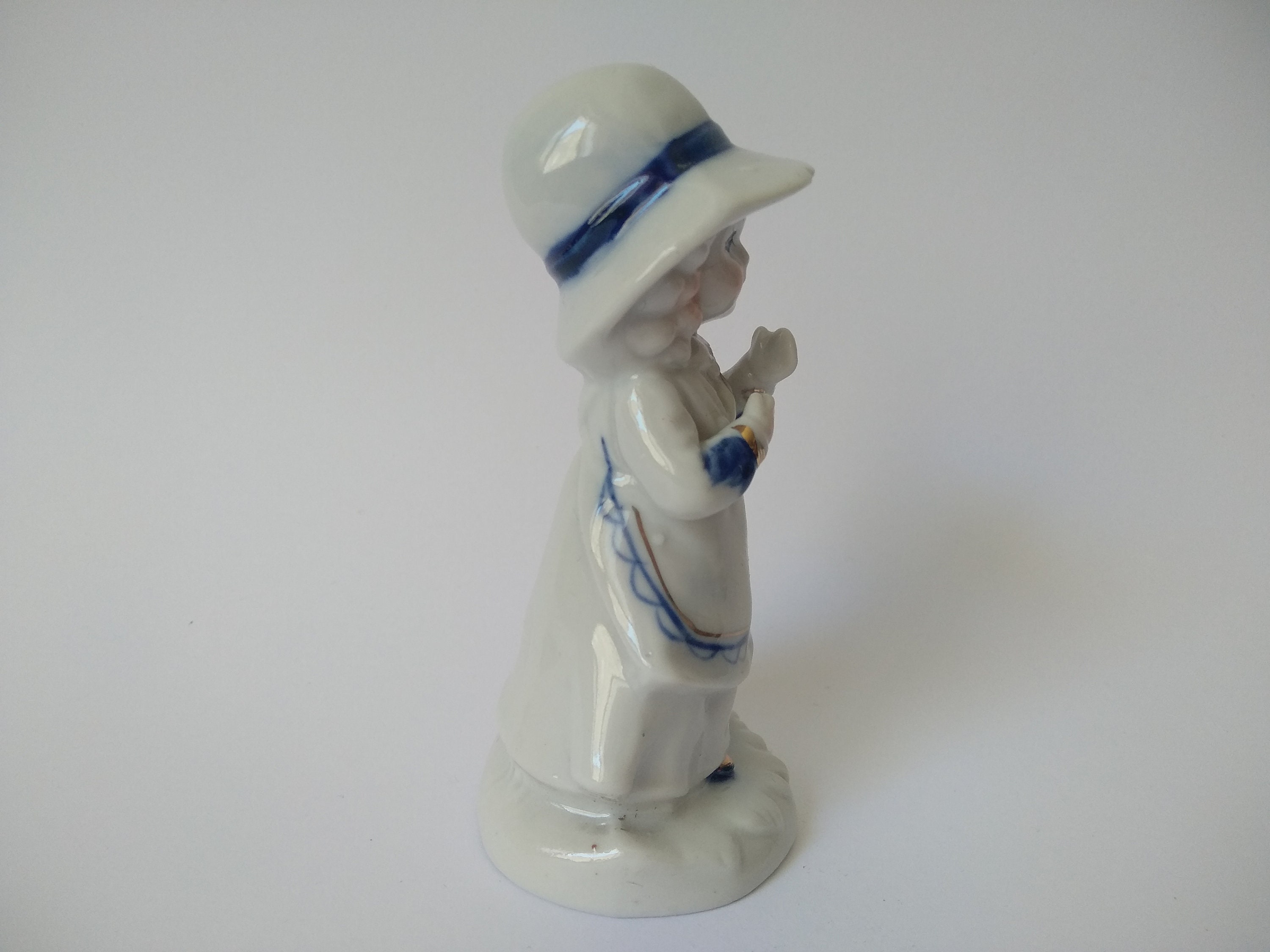 A Porcelain Figurine in the Shape of a Cute Little Girl. Made From Hard ...