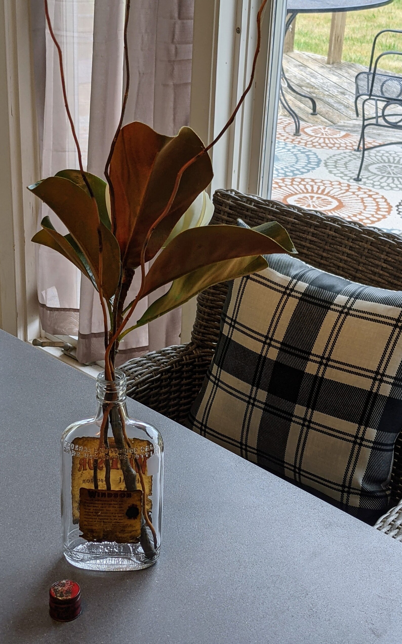Magnolia flower in a vintage Bourbon bottle. | Etsy