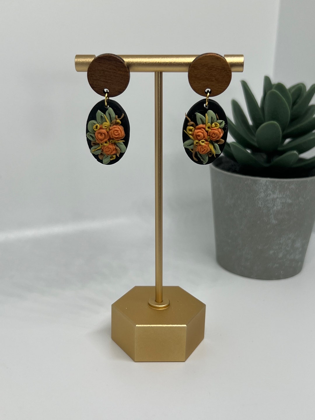 Black Oval With Orange and Yellow Florals on Wood Hardware | Polymer ...