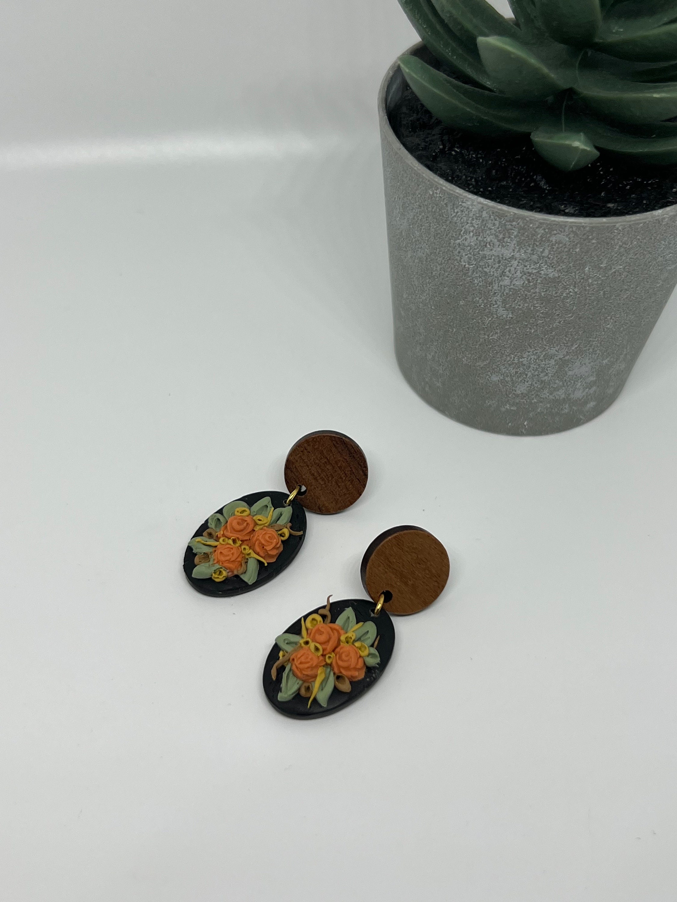 Black Oval With Orange and Yellow Florals on Wood Hardware | Polymer ...