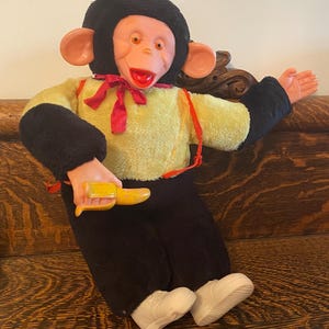 Stuffed monkey with banana in hand store
