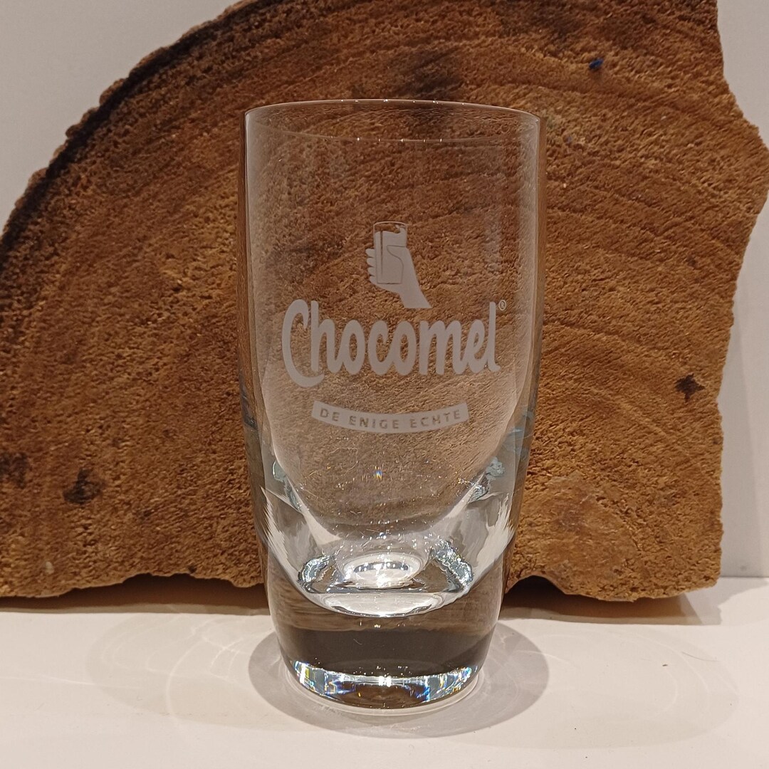A Clear Chocomel Glass, With the Logo of the 'hand With the Glass of ...