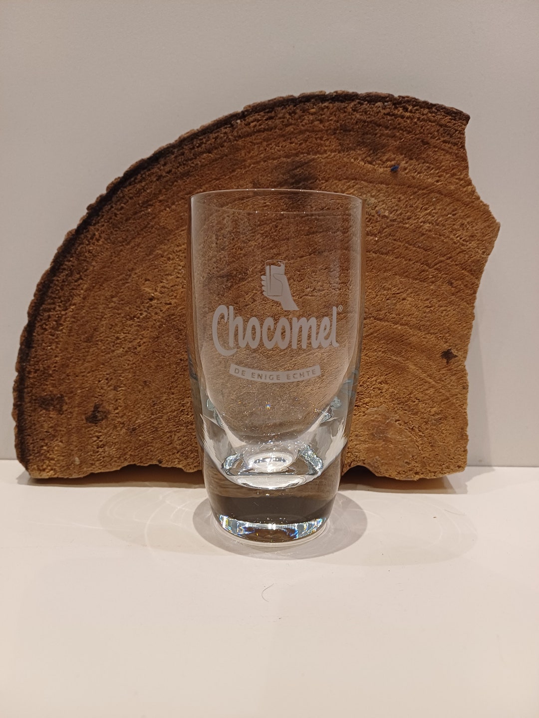 A Clear Chocomel Glass, With the Logo of the 'hand With the Glass of ...
