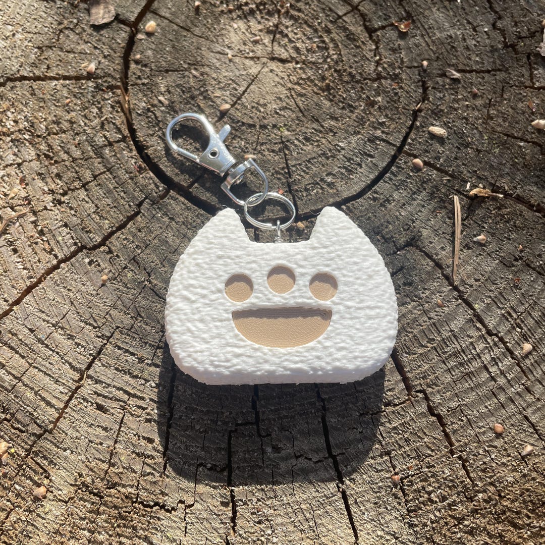 Monster Hunter Wilds Keyring and Mirror Charm - Palico Hat Symbol ...