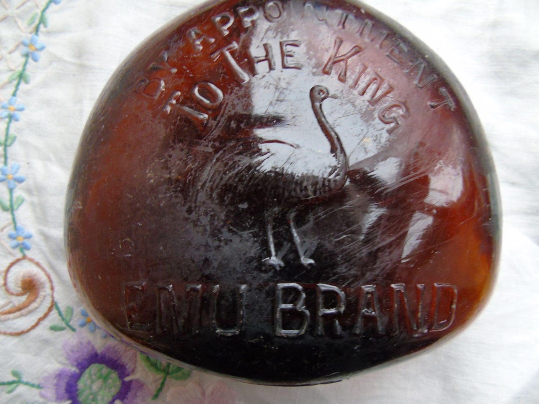 An Emu Brand Antique Burgundy Bottle. by Appointment to the King. Made ...