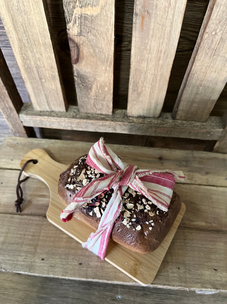 Faux Bread Loaves With Oatmeal Topping on Cutting Board or in Baking ...