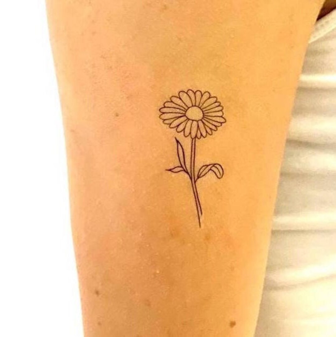 Small Yellow Daisy Tattoo