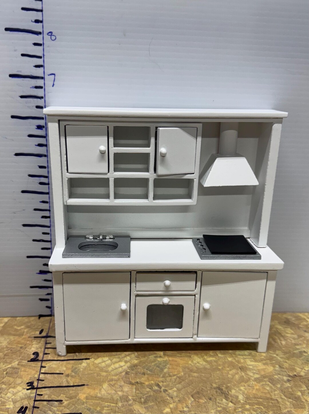 The Kitchen Features White Cabinets, a White Bell Extractor, and a Grey ...