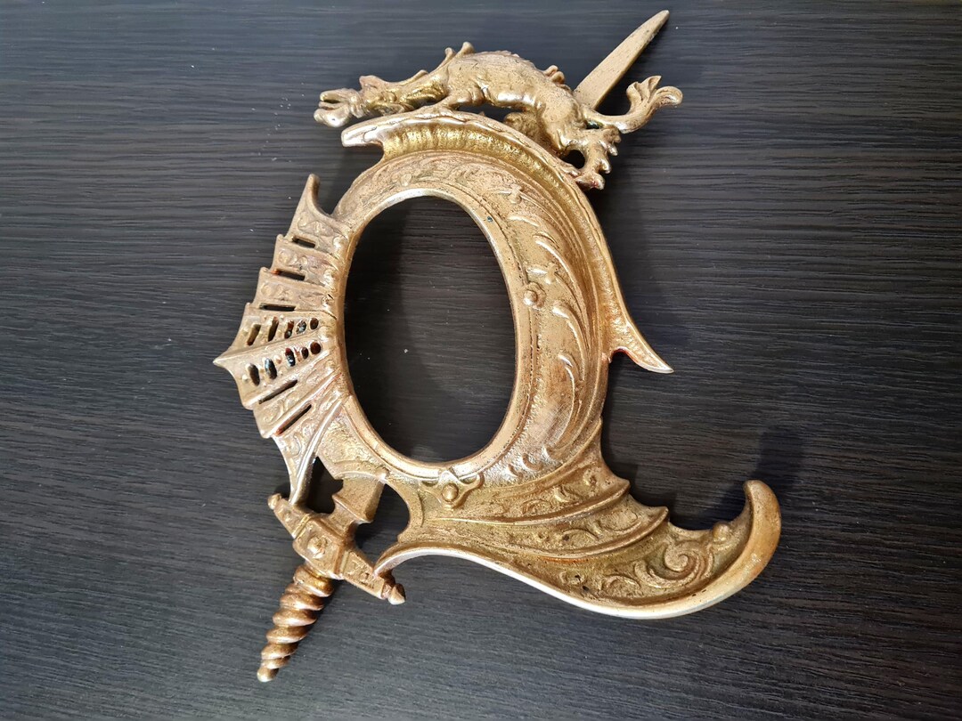Vintage Ornate Gold Dragon Frame on Knight's Helmet, Mythical Sword ...