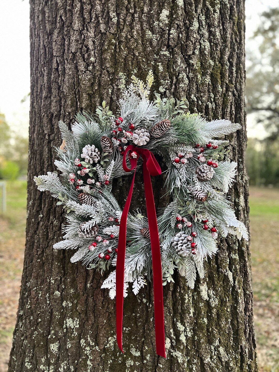 Snow Flocked Christmas Wreath With Pine Cones and Frosted Red Berries ...