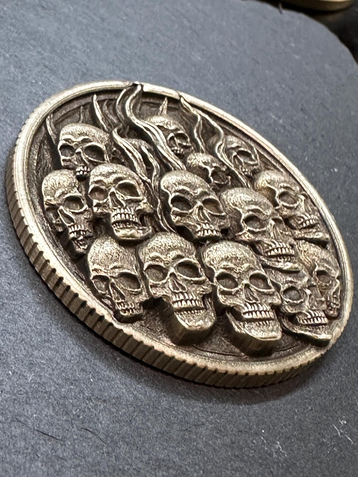 3D Laser Engraved Brass Coin. Extra Deep Engraving of a Pile of Skulls ...