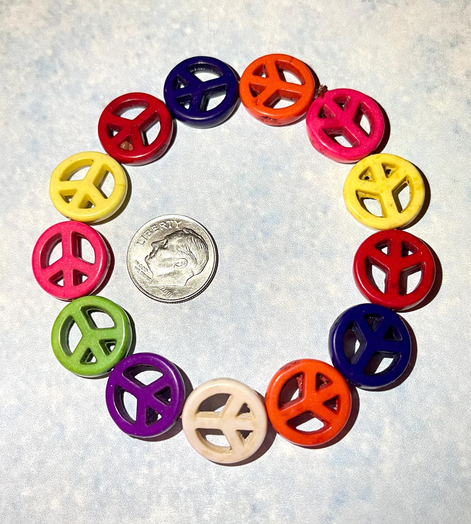 Strand of 13 Dyed Magnesite Peace Sign Beads on A Stretch Cord-15mm ...