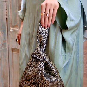 Hakaya Knot Bag | Black and Gold Arabic Calligraphy Purse | Cultural ...