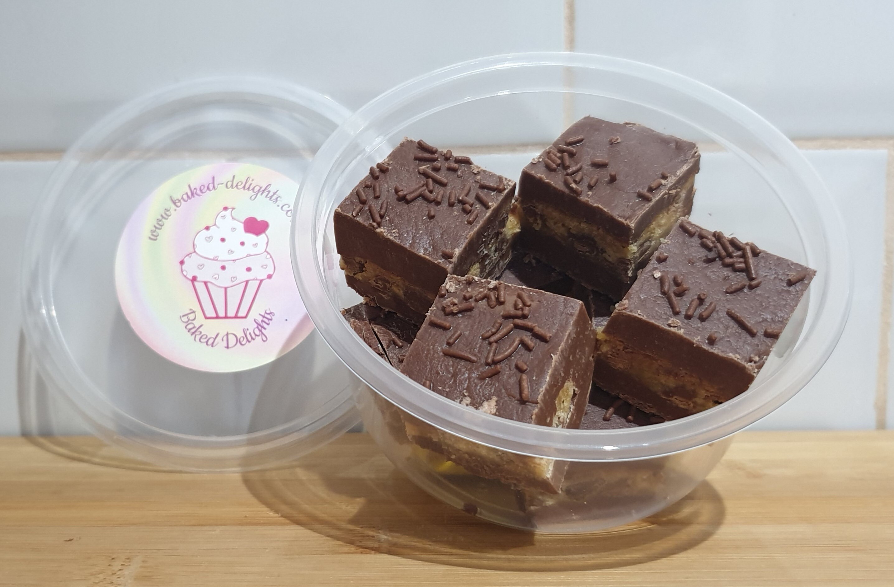 Chocolate and Cookie Layered Fudge Squares Presented in a Clear Tub ...