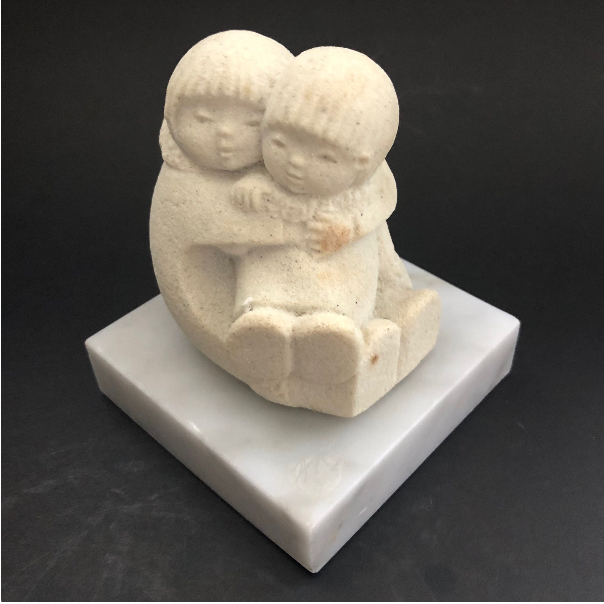 Vintage Marbell by Stone Art Hugging Children in Parkas on Marble Base ...
