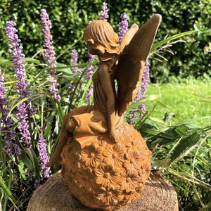 Gorgeous Garden Fairy - Cast Iron Elf Sitting on a Sphere of Flowers ...