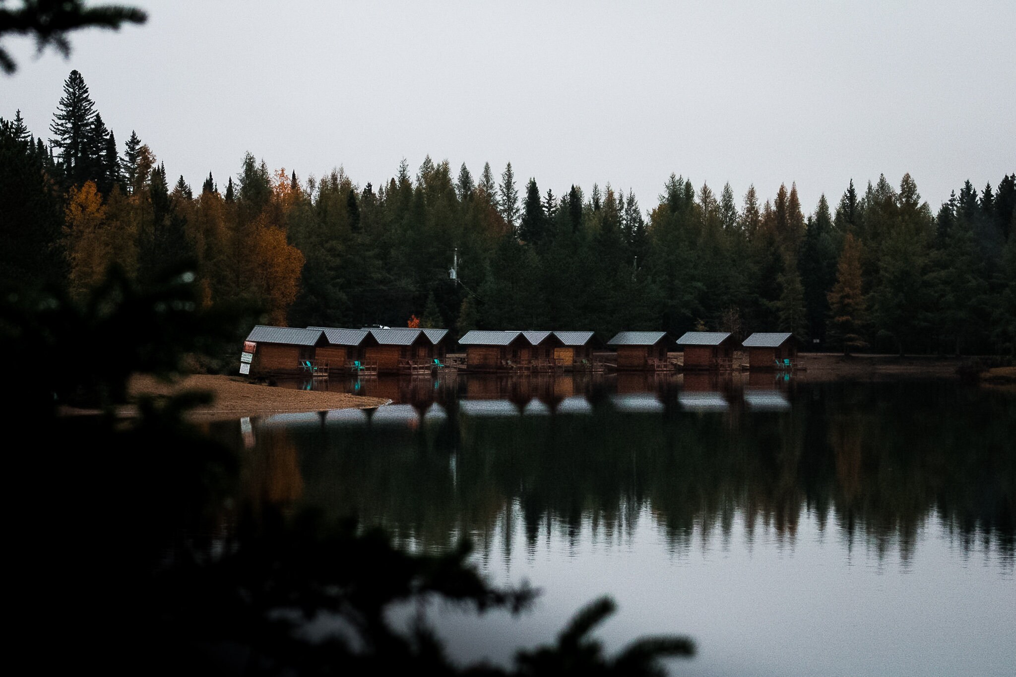 Remote Cabin in the Woods, A Line of Small Cabins Circle the Shore of ...