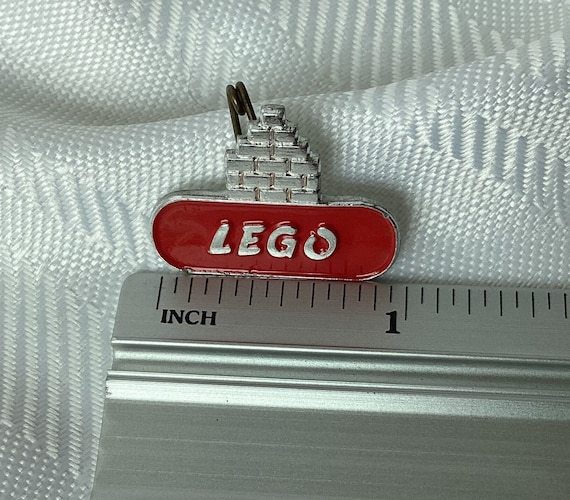 Lego pin Advertising, old font, stacked bricks on red… - Gem