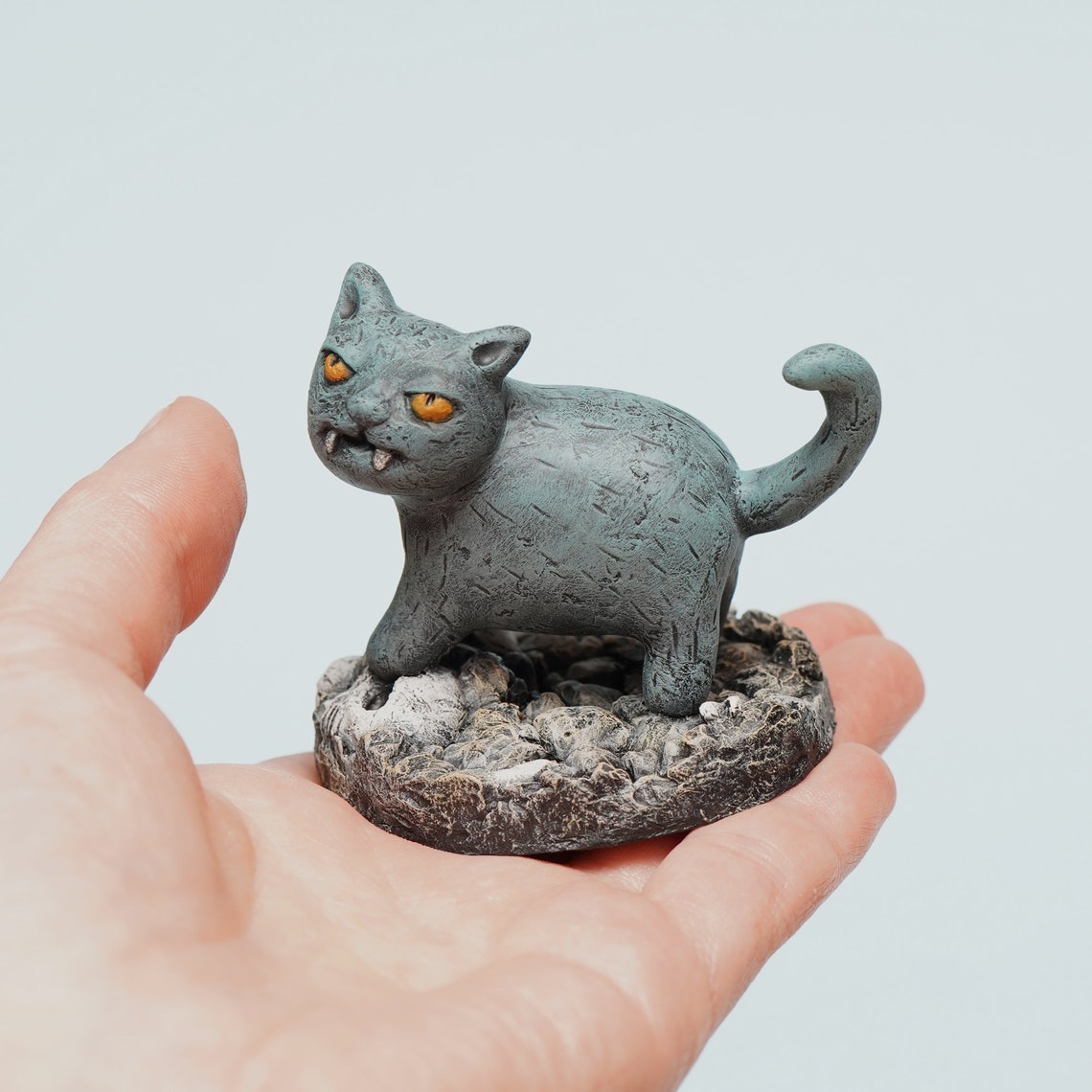 Grumpy Blue Cat Standing on Rocky Base With Skulls. Beautiful Colorful ...