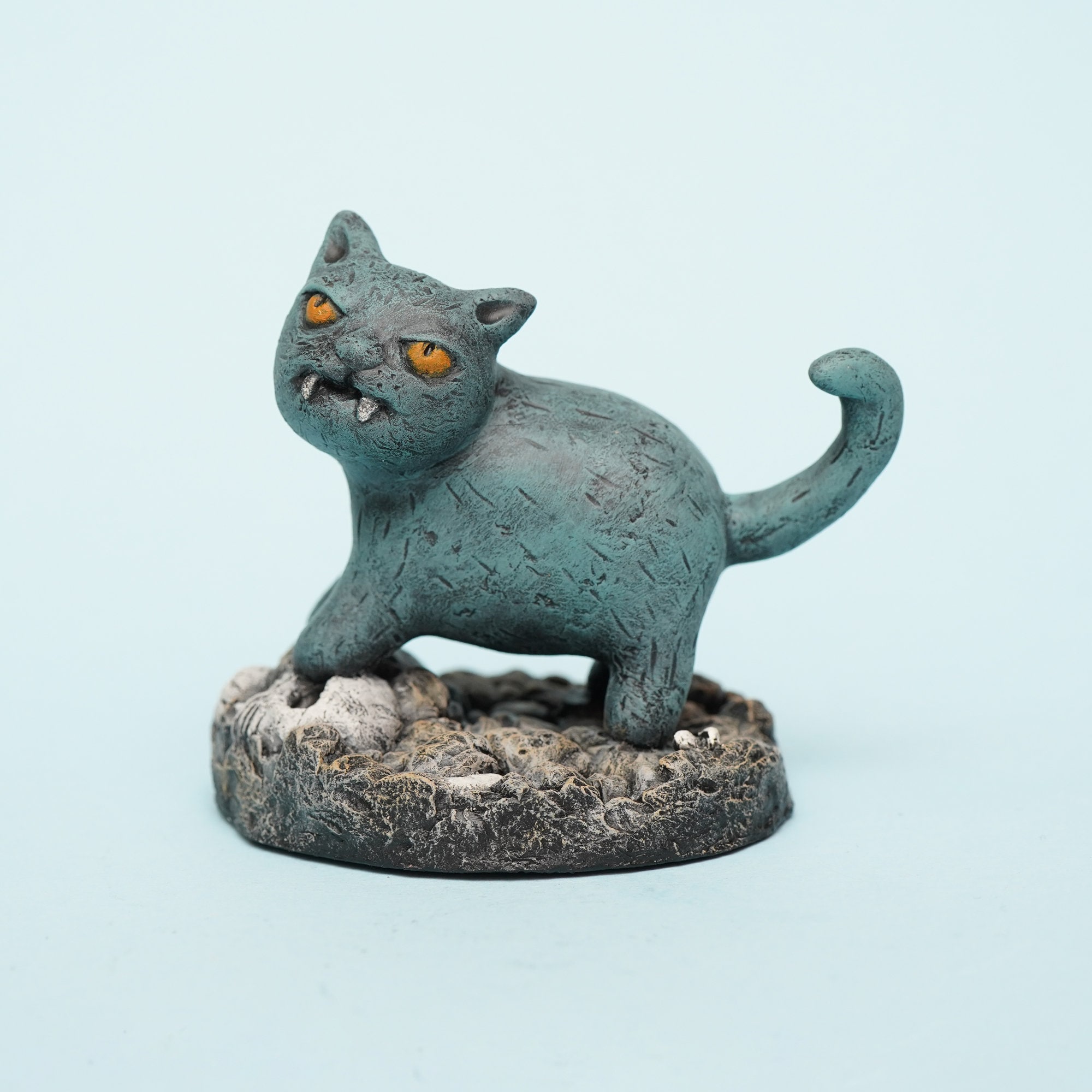 Grumpy Blue Cat Standing on Rocky Base With Skulls. Beautiful Colorful ...