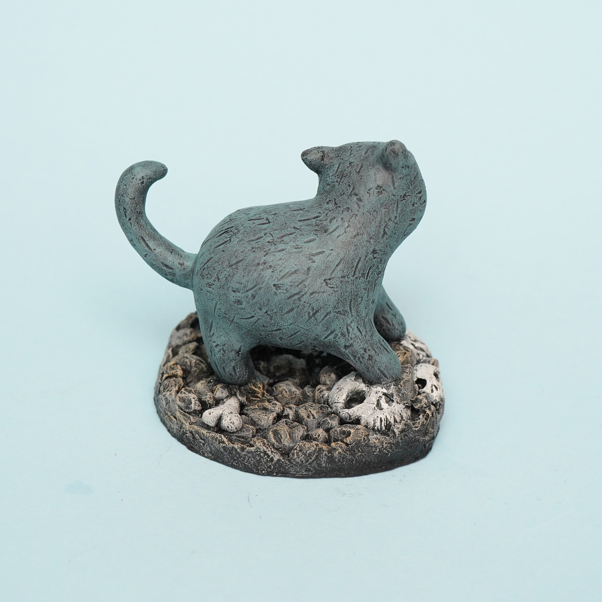 Grumpy Blue Cat Standing on Rocky Base With Skulls. Beautiful Colorful ...