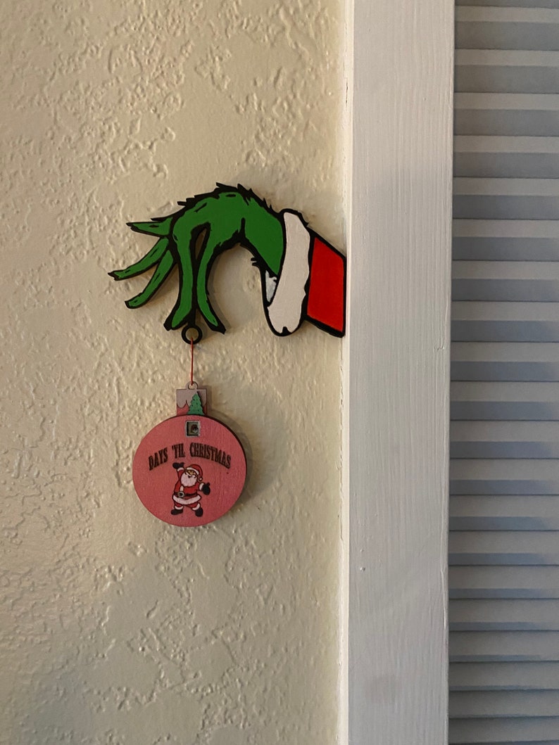How The Grinch Stole Christmas Grinchs Hand Holding An Ornament Hanging On Wall By A Door Or