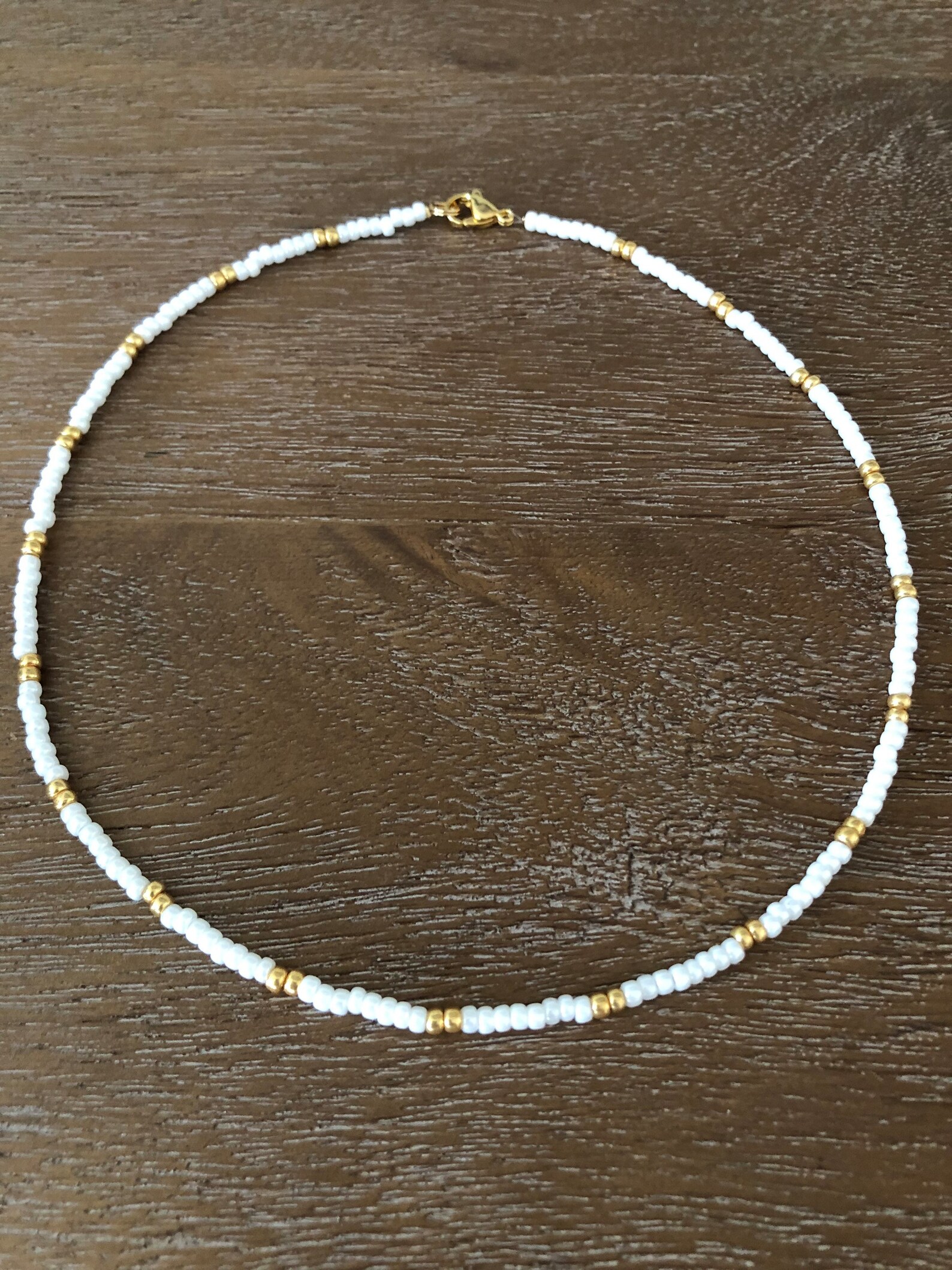 Infinitely Elegant: Minimalist White Beaded Necklace Detailed With Gold ...