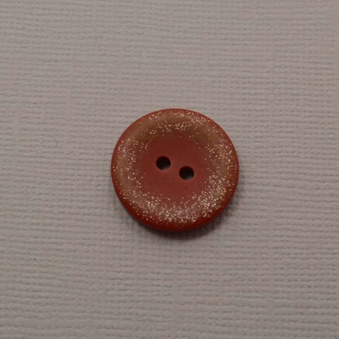 Dark Red Round Button With a Light Dusting of Gold Sparkles Around the ...